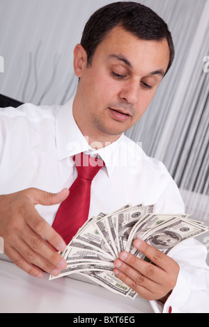 Businessman at the office enjoying his money Stock Photo - Alamy