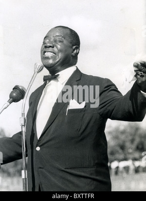 LOUIS ARMSTRONG (1901-1971) US jazz musician is presented with a ...