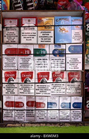 Assorted cigarette packets on sale with health warnings in Spanish ...