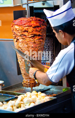 Meat roasted on a vertical spit before making a shawarma Stock Photo ...