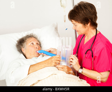 spirometer for breathing exercises. senior woman in hospital room ...