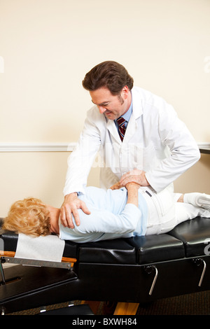 Chiropractor adjusting a female patient's spine. Plenty of room for ...