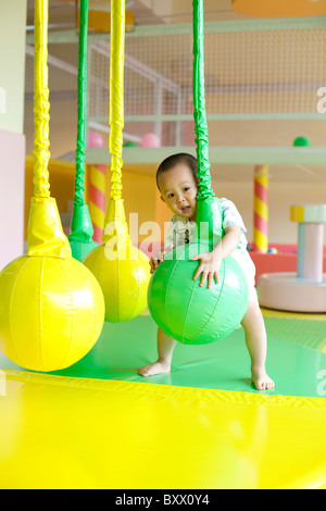 Cute preschool child, boy, holding little brown teddy bear in the park ...