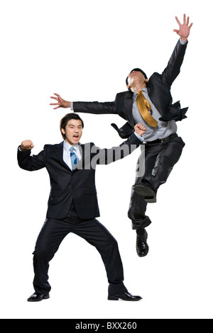 Two businessmen fighting on white background Stock Photo - Alamy