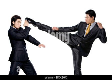 Two businessmen fighting on white background Stock Photo - Alamy