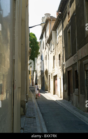 Very narrow cobbled street in the shade that makes a bend at the end in ...