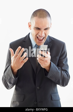 Businessman yelling into phone, close-up Stock Photo - Alamy