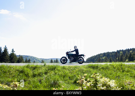 motorbike on the forest road riding with spotlights. driving on the ...