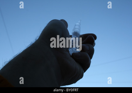 Hand with the magic wand of ice, icicle, mountains, blue sky Stock ...