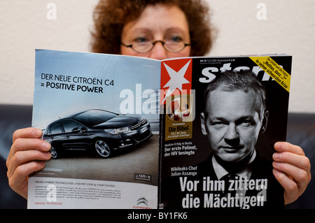 German woman reading weekly news and events magazine Stern Stock Photo ...