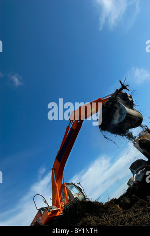 Tracked excavator on landfill Stock Photo - Alamy