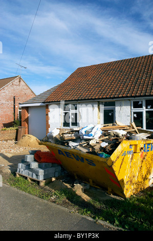 Building skip in front of house Stock Photo - Alamy
