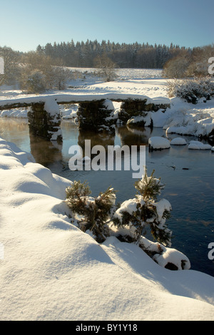 Snow covered clapper bridge in Winter at Postbridge Dartmoor Devon UK ...
