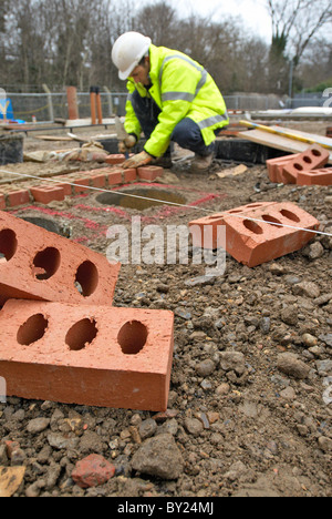 A construction worker laying drainage pipes Stock Photo - Alamy