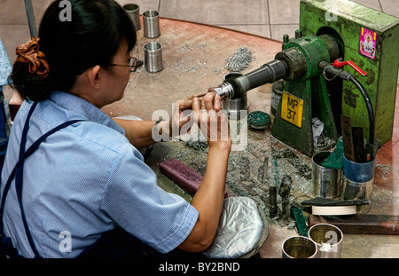 Worker finishing product design in Pewter Factory called Royal Selangor ...