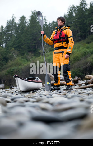 USA, Washington State. Male kayaker paddling sea kayak on still water ...