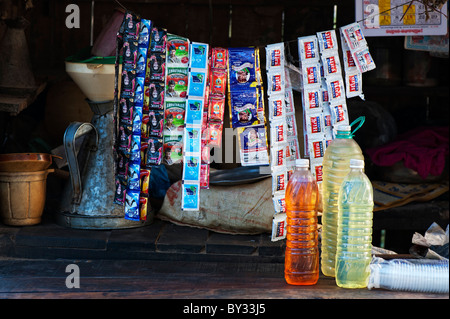 Indian petrol sold in plastic bottles with packets of crisps outside a ...