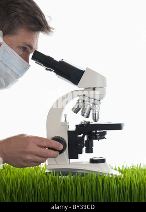 Mature man looking into microscope Stock Photo - Alamy