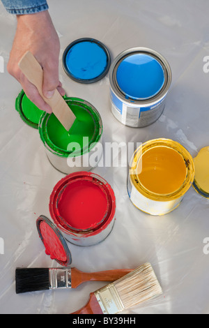 Colorful paint cans with paintbrush Stock Photo - Alamy