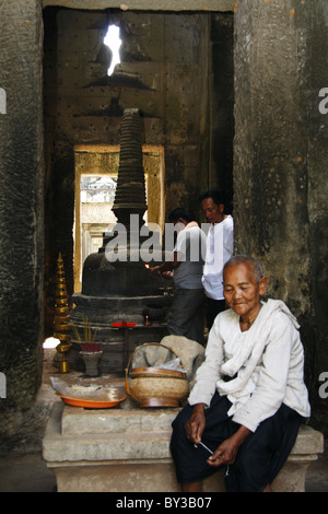 Old woman at the stupa in the sanctuary of Preah Khan Temple, Angkor ...