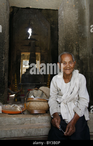 Old woman at the stupa in the sanctuary of Preah Khan Temple, Angkor ...
