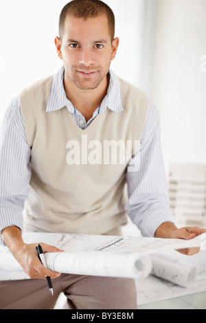 Portrait of a young businessman holding a pen Stock Photo - Alamy