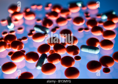 Scattered pharmaceutical medicine pills, tablets and capsules on dollar ...