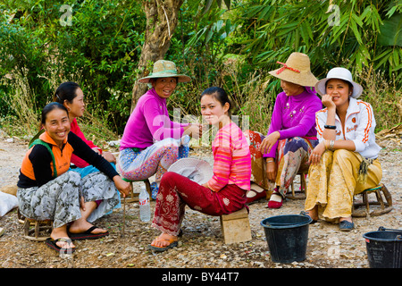 Chinese women of Dai ethnic minority pour water on the ground to ...