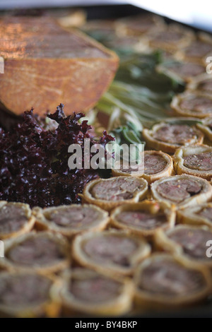 Sliced pork sausage with salad leaves Stock Photo - Alamy
