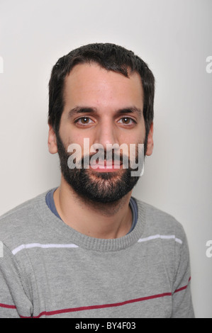 Young 30s arab bearded man millennial guy in glasses sits at home on ...