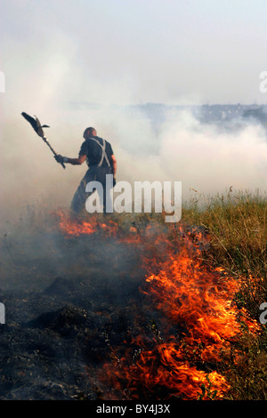 Firefighters using water fire extinguisher to fighting with the fire ...