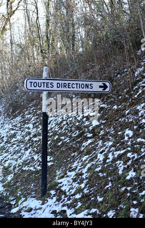 ALL DIRECTIONS / Toutes Directions. Road sign in France, against a deep ...