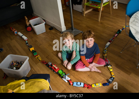 Two blonde boys playing with cars Stock Photo - Alamy