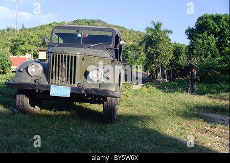 Cuban jeep parked in a field in Holguin (Cuba) with the Loma background ...