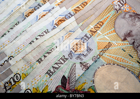 Stacks of ten 10 pound notes Sterling on a white background ...