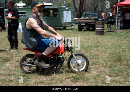 man riding mini motorcycle Stock Photo - Alamy