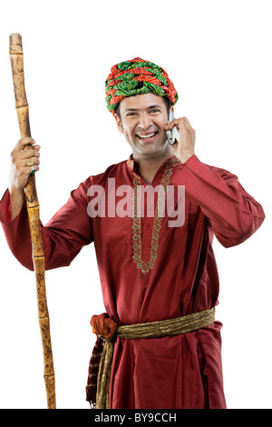Gujarati man talking on a mobile phone Stock Photo - Alamy