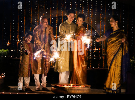 Family playing with firecrackers Stock Photo - Alamy