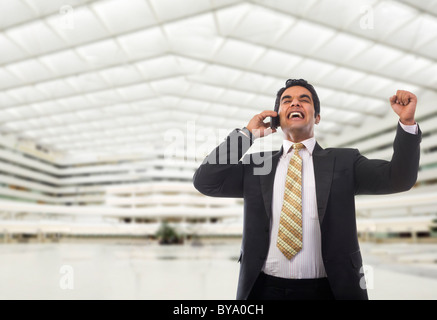 Asian Businessman Getting Excited At Office Desk Stock Photo - Alamy