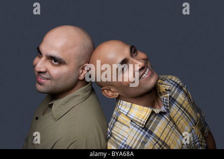 Two bald men sitting together Stock Photo - Alamy