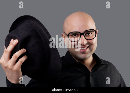 Bald man taking off his hat Stock Photo - Alamy