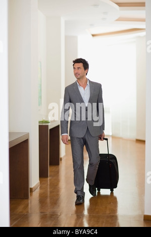 businessman walking through hotel lobby Stock Photo - Alamy