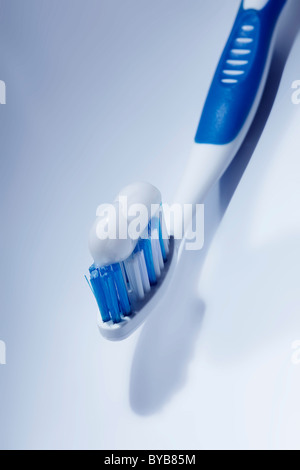 A single blue tooth brush lies on a white background Stock Photo - Alamy
