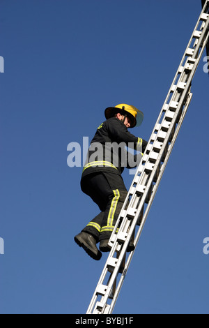 Fireman climbing a ladder Stock Photo - Alamy