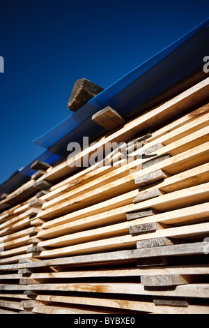 Stacks of planks against the deep blue sky Stock Photo - Alamy