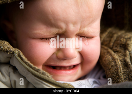 A young girl cries in pain after falling with a sprained ankle at the ...