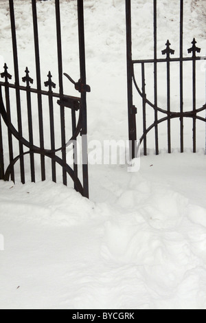 Wrought iron gate covered by rust on old mansion with stone decoration ...