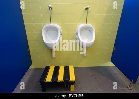 Public urinals with step for kids Stock Photo - Alamy