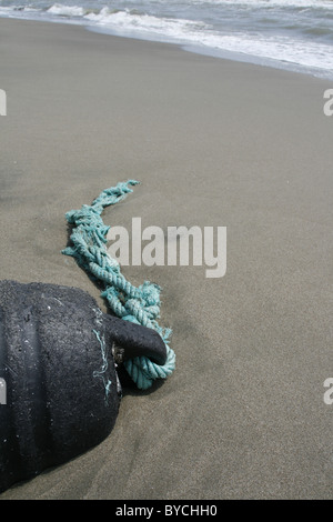Old buoy washed up on a sunny sand beach Stock Photo - Alamy