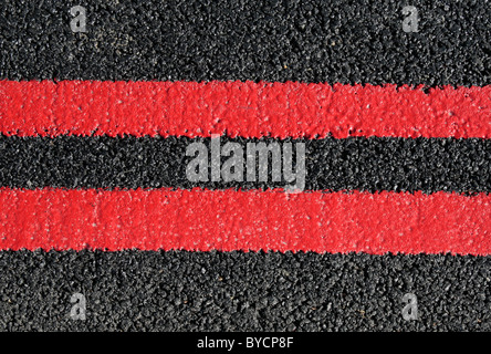 Double red lines on a red route in London Stock Photo - Alamy